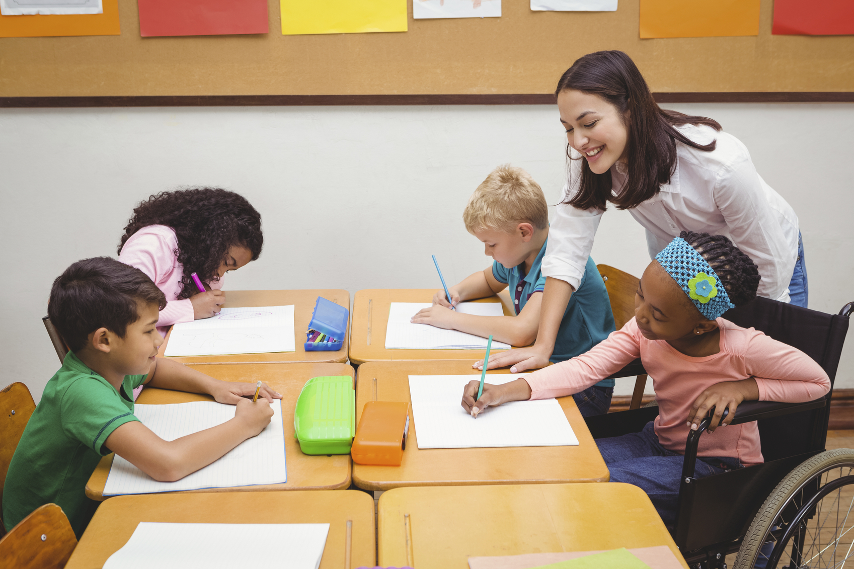 Happy teacher helping her students - WSPTA